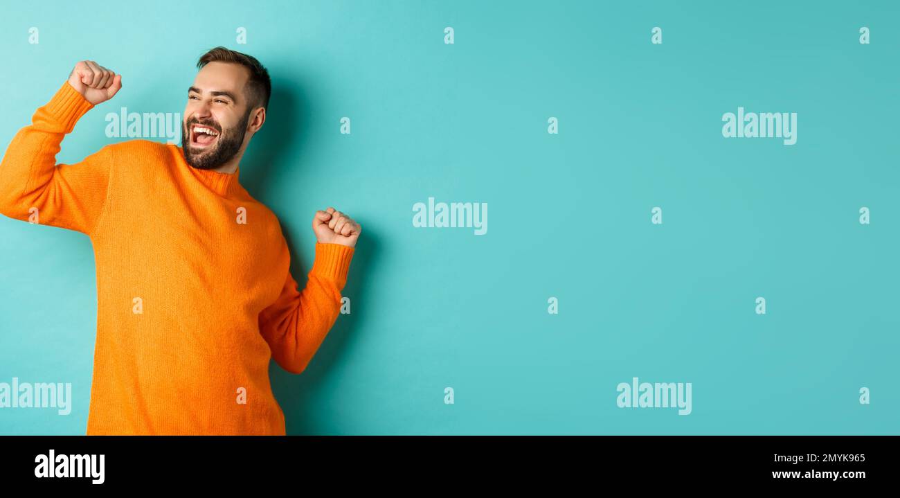 Happy man raising arm, feeling like winner, triumphing and celebrating ...