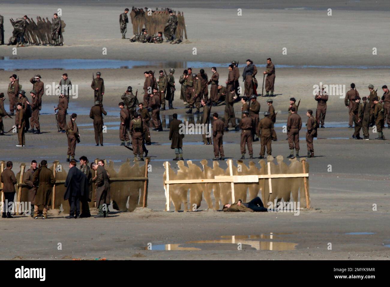 Actors wait on the beach before filming a scene for the film, "Dunkirk ...