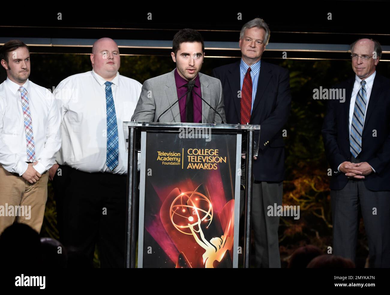 Jordan Kamalu, center, of Brigham Young University accepts the music ...