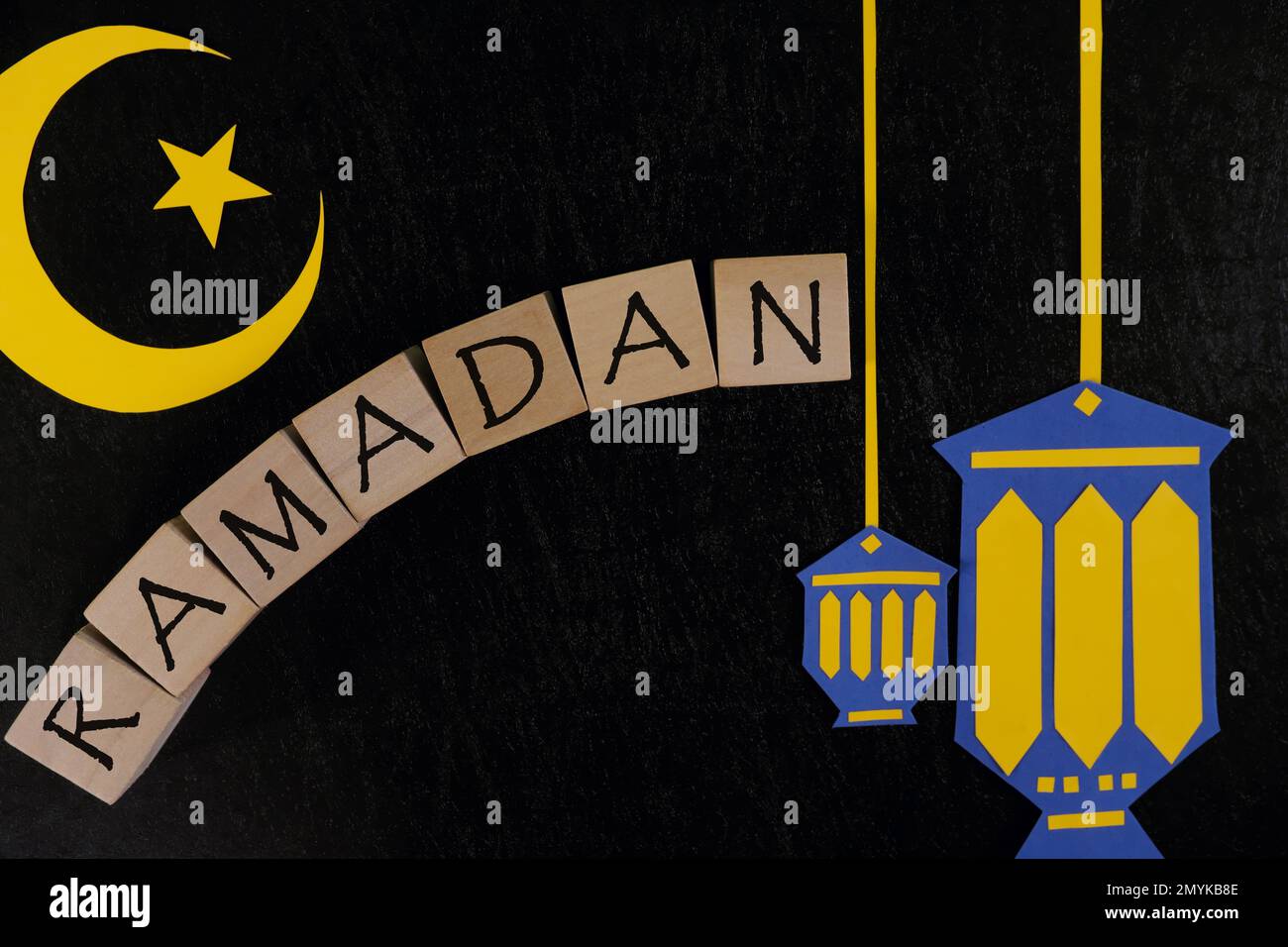 Crescent moon, star and lantern decoration with text on wooden blocks ...