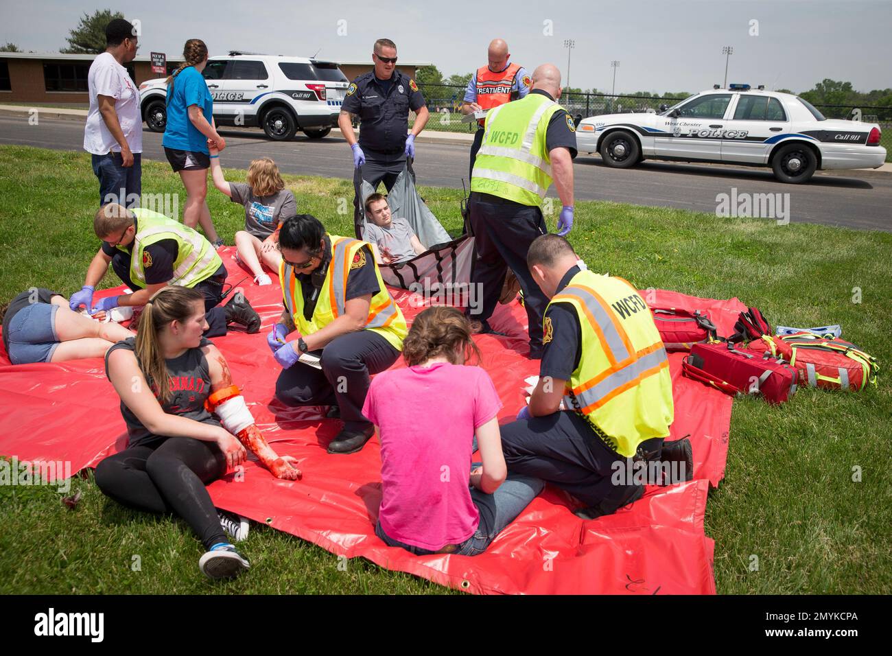 Volunteers with simulated injuries are delivered to a mock triage ...