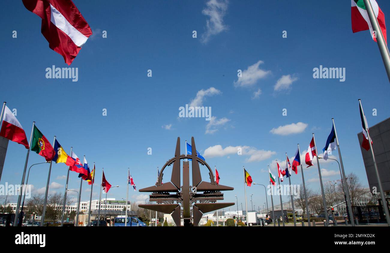 FILE - In this March 2, 2014 file photo, the NATO symbol and flags of ...