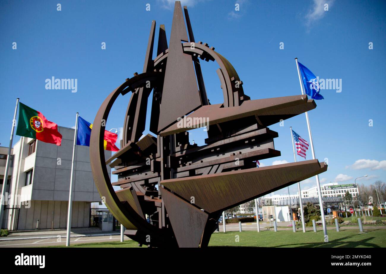 FILE - In this March 2, 2014 file photo, the NATO symbol and flags of ...