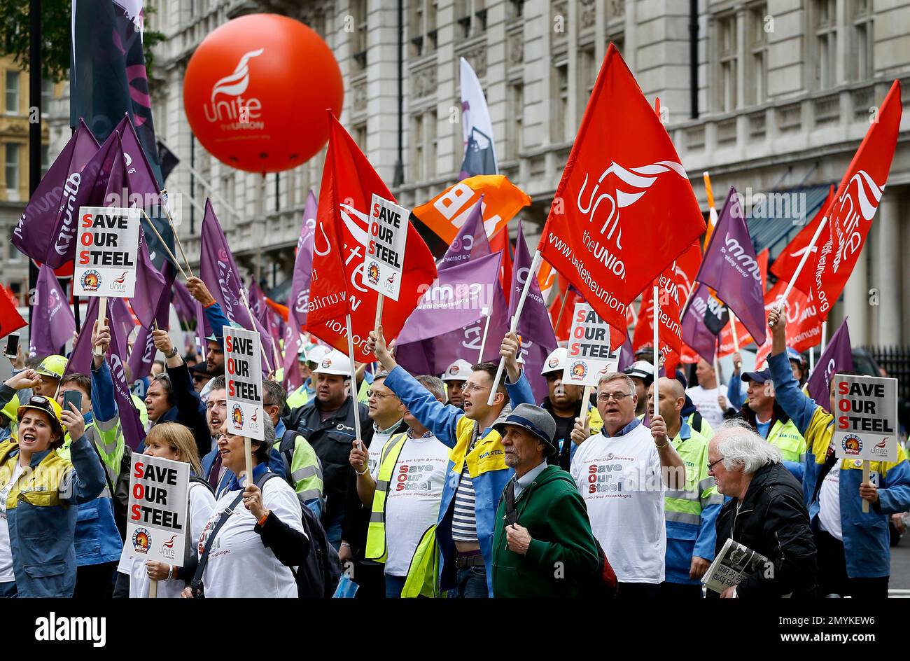 Steelworkers wave banners during a march through Westminster in London ...