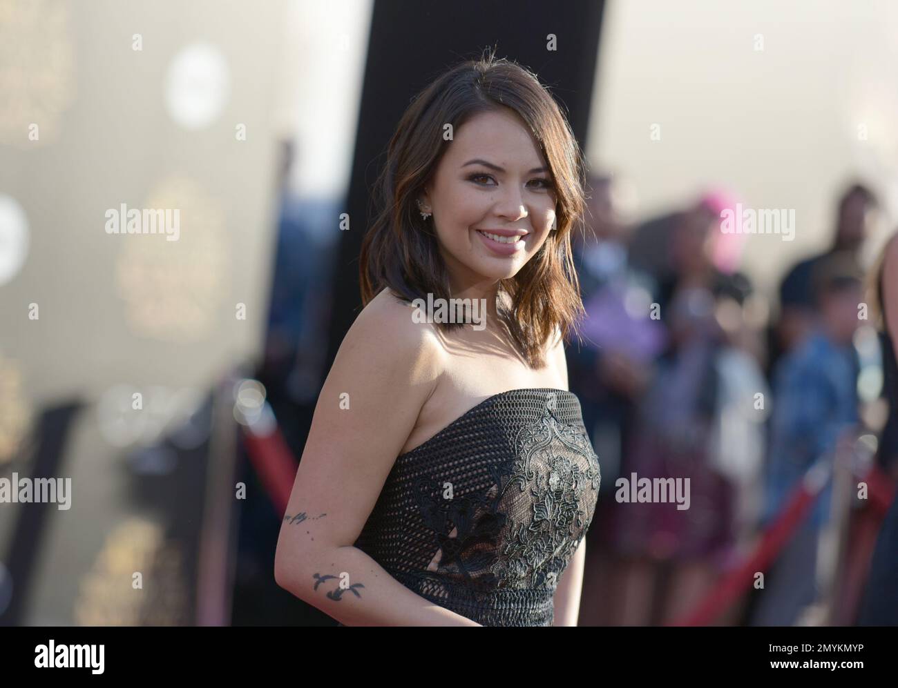 Janel Parrish arrives at the premiere of "Alice Through the Looking ...