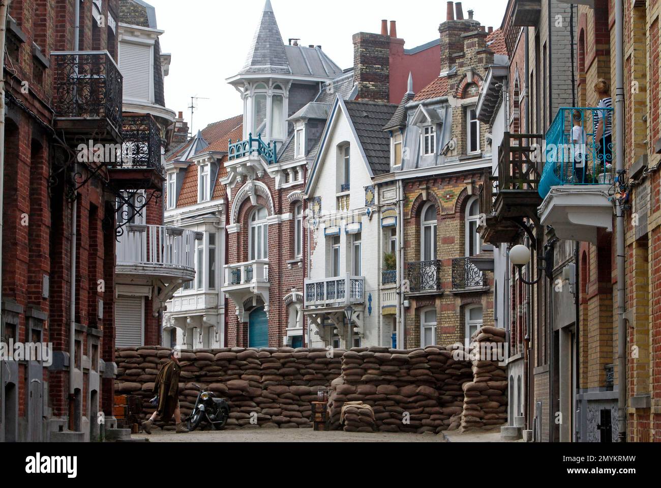 An actor walks on the set before filming a scene for the film, "Dunkirk ...