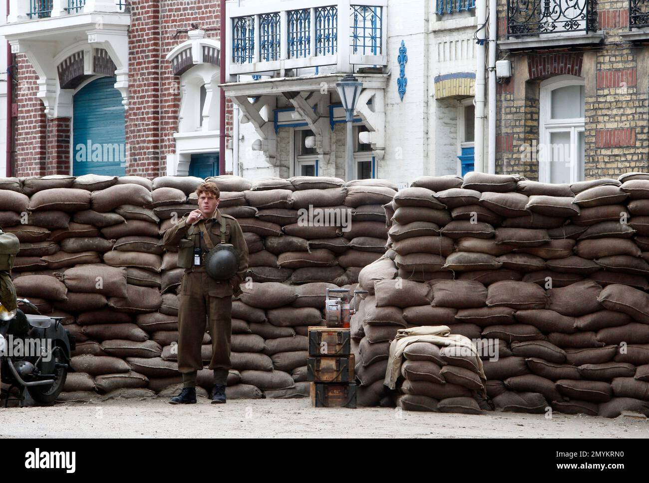 An actor waits before filming a scene for the film, "Dunkirk," in ...