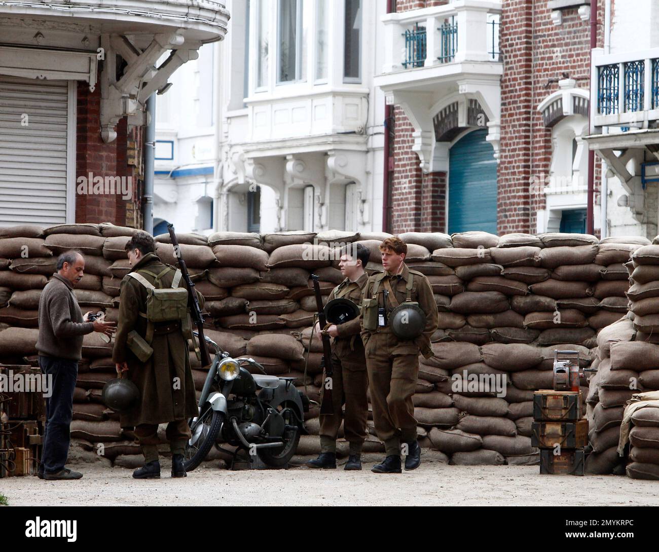 Actors wait on the set before filming a scene for the film, "Dunkirk ...