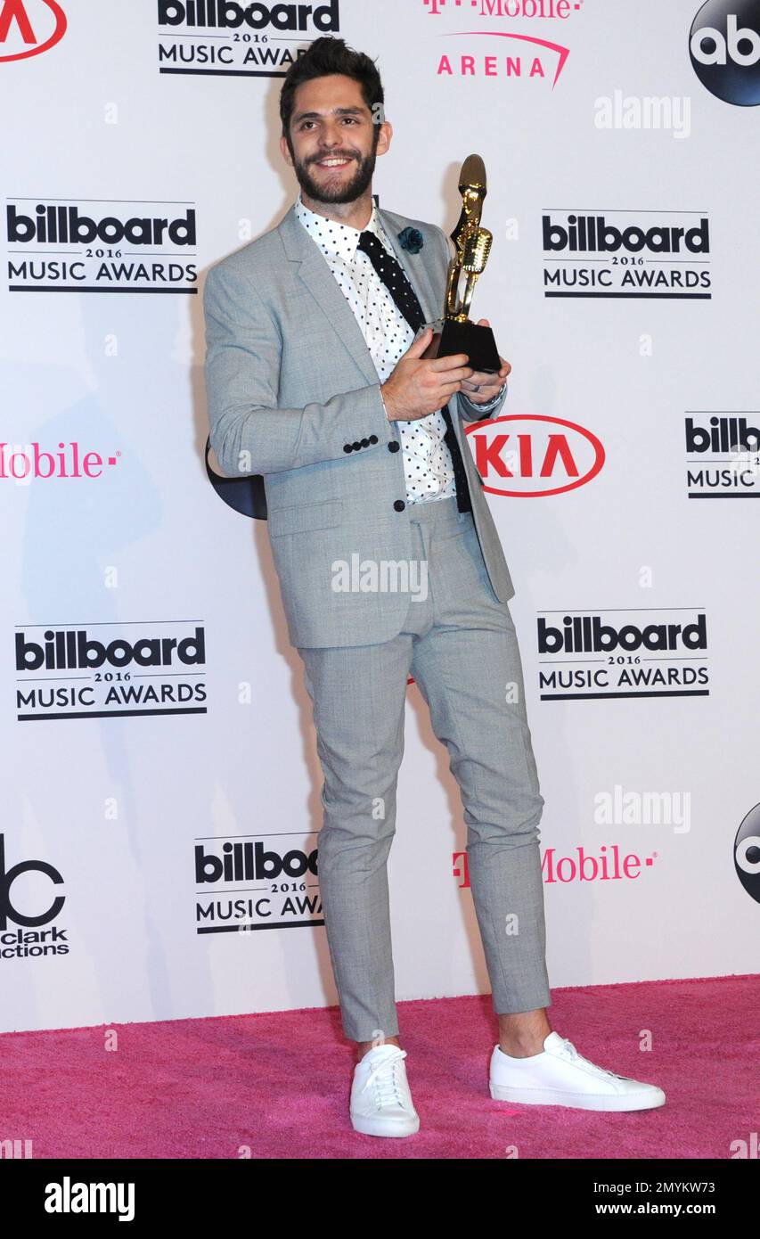 Thomas Rhett poses in the press room with the award for top country ...