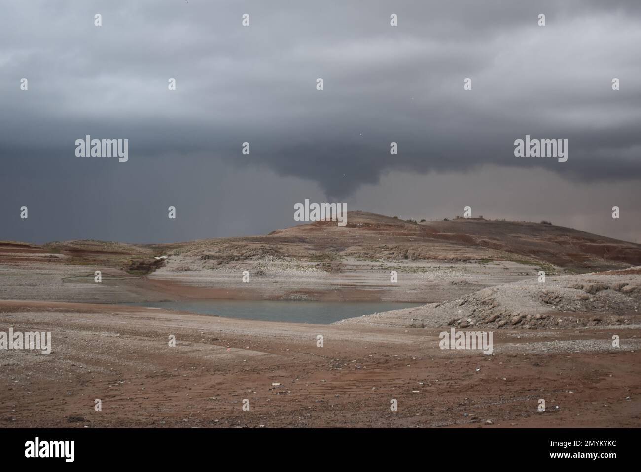 A storm brewing over the low water and dry shores of the Tigris River ...