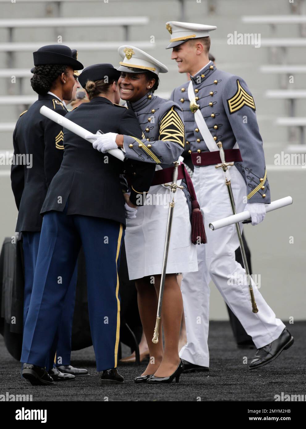 Cadets are congratulated after receiving diplomas during a graduation ...