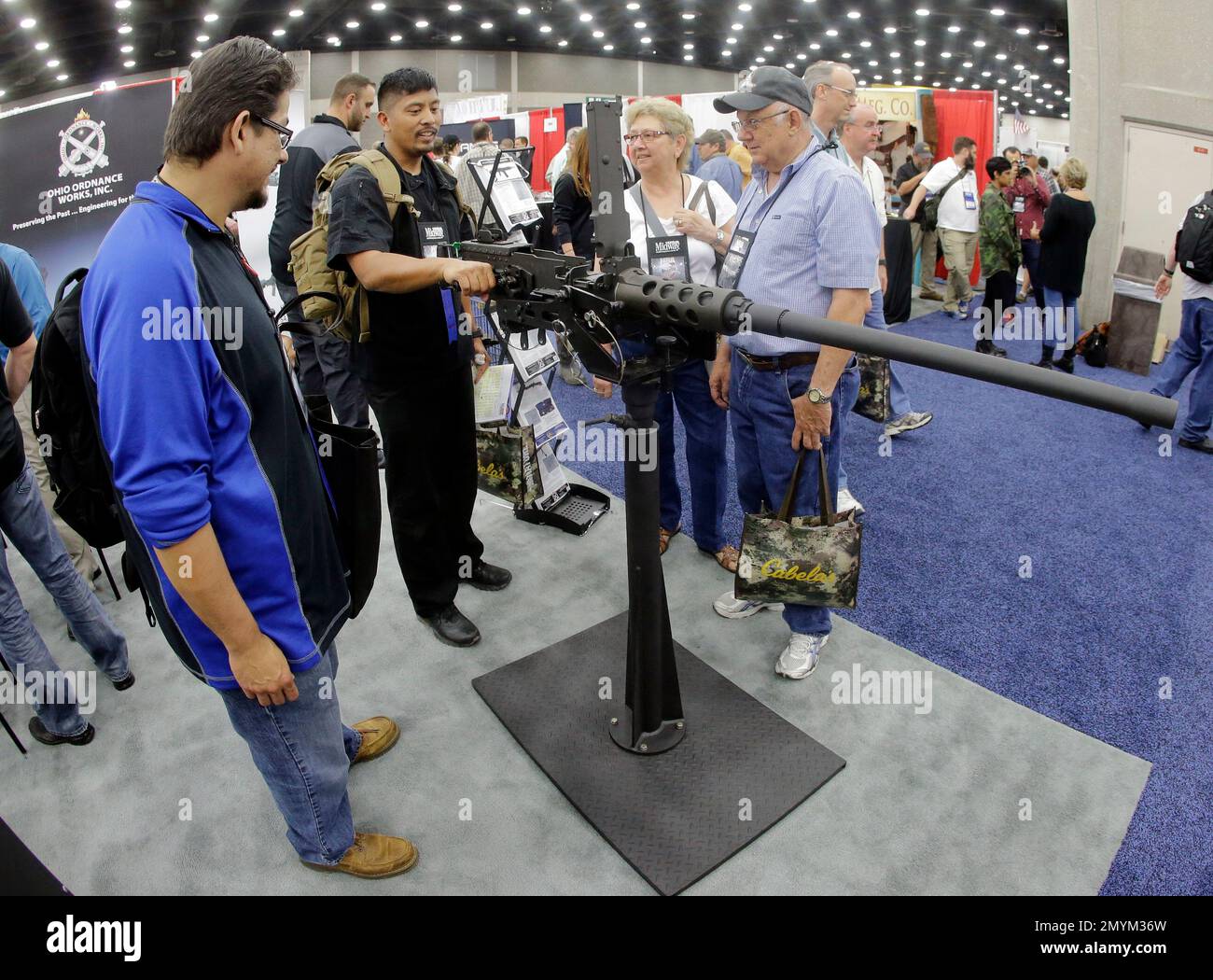 Retired Army Maj. Noel Zarza, center, of Bloomington, Ill., examines a ...
