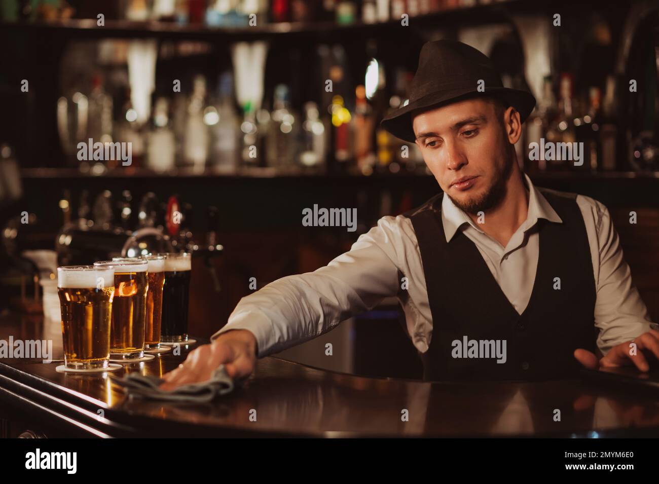 bartender with a beard wipes bar counter in a pub with a rag Stock ...