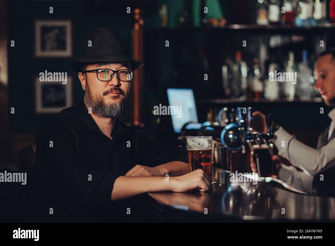 Man sitting in a pub drinking a pint of beer hi-res stock photography ...