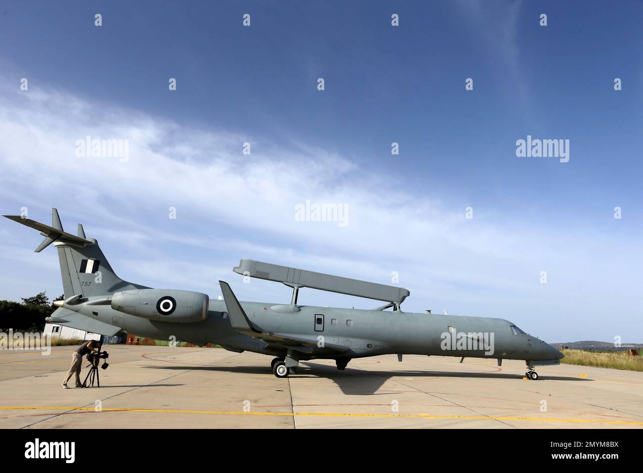 A cameraman records an Erieye EMB-145H AEW&C radar aircraft of the ...