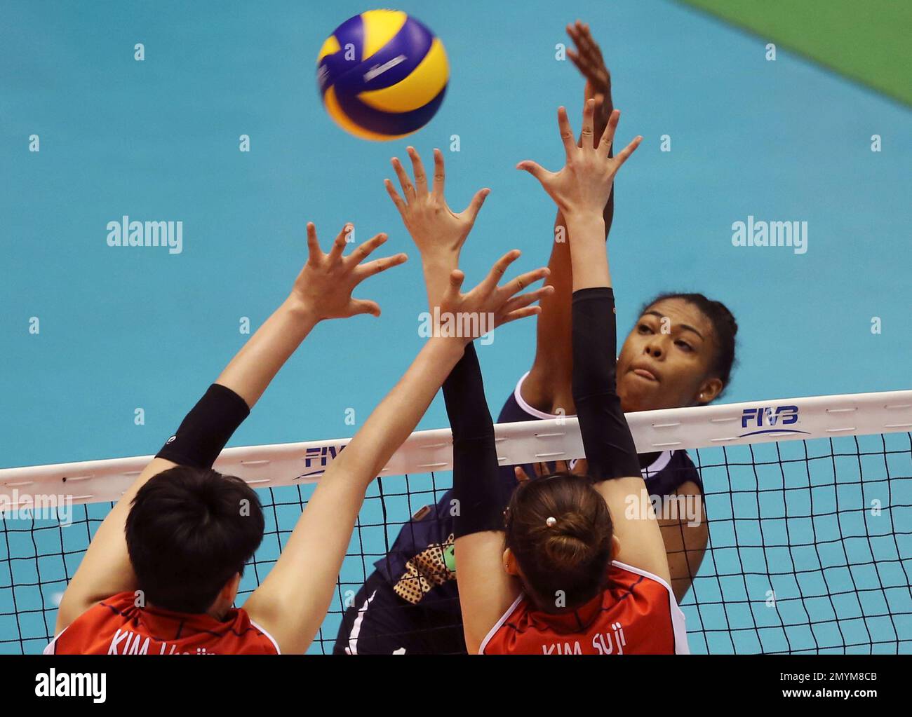 Angela Leyva of Peru spikes the ball against South Korea during their ...