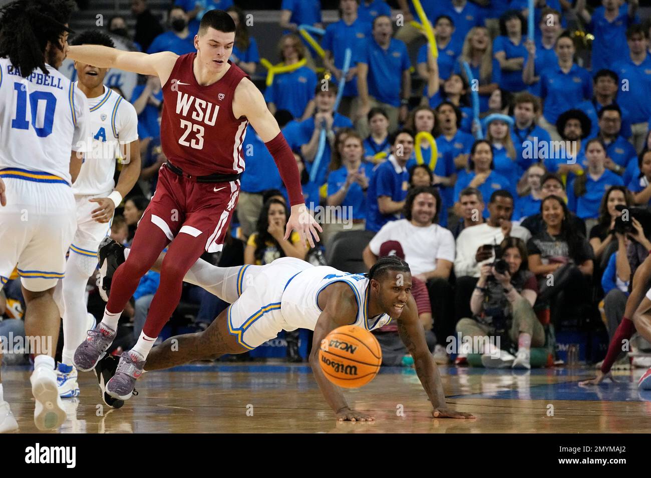 UCLA guard David Singleton, right, and Washington State forward Andrej ...