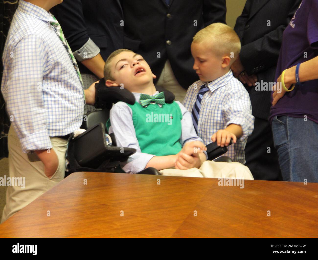 Connor Corkern, in a wheelchair, and his family await Gov. John Bel ...