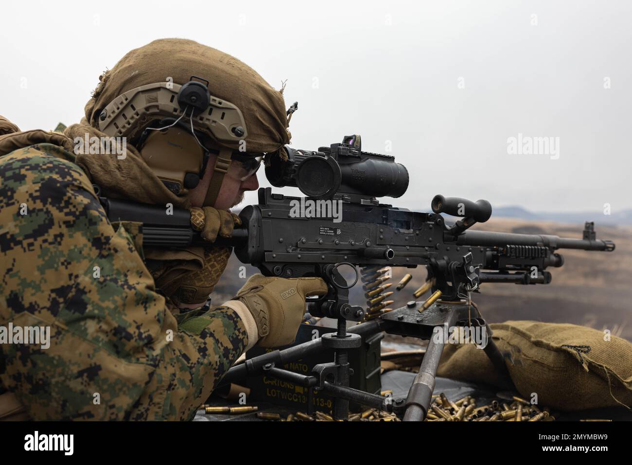 A U.S. Marine with 3d Battalion, 4th Marines fires an M240B machine gun during exercise Fuji ...