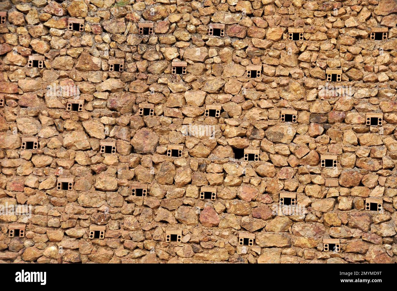 Natural stone wall of a mine with ventilation holes Stock Photo - Alamy