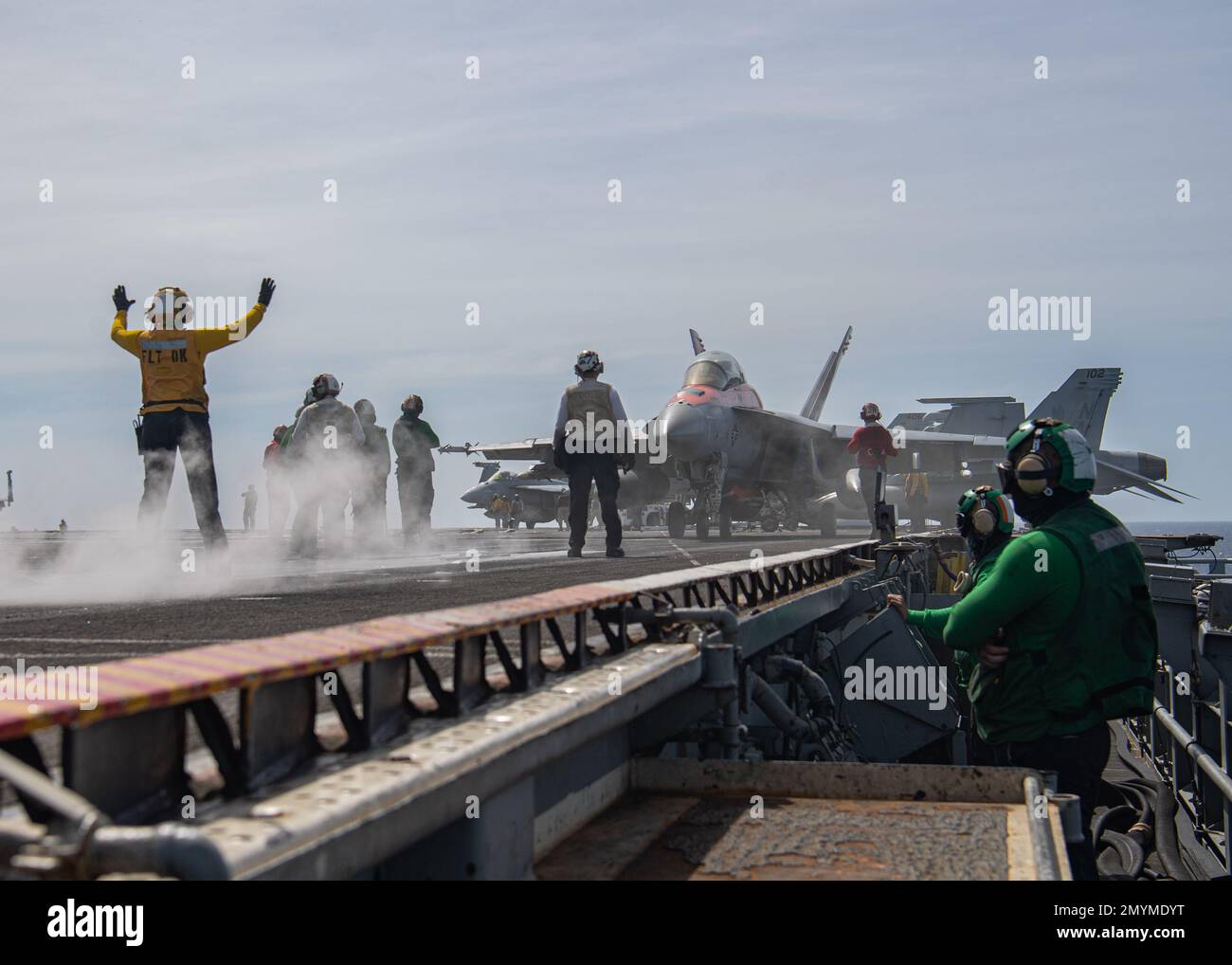 230203-N-MH015-1051 SOUTH CHINA SEA (Feb. 3, 2023) A U.S. Navy Sailor directs an F/A-18F Super ...