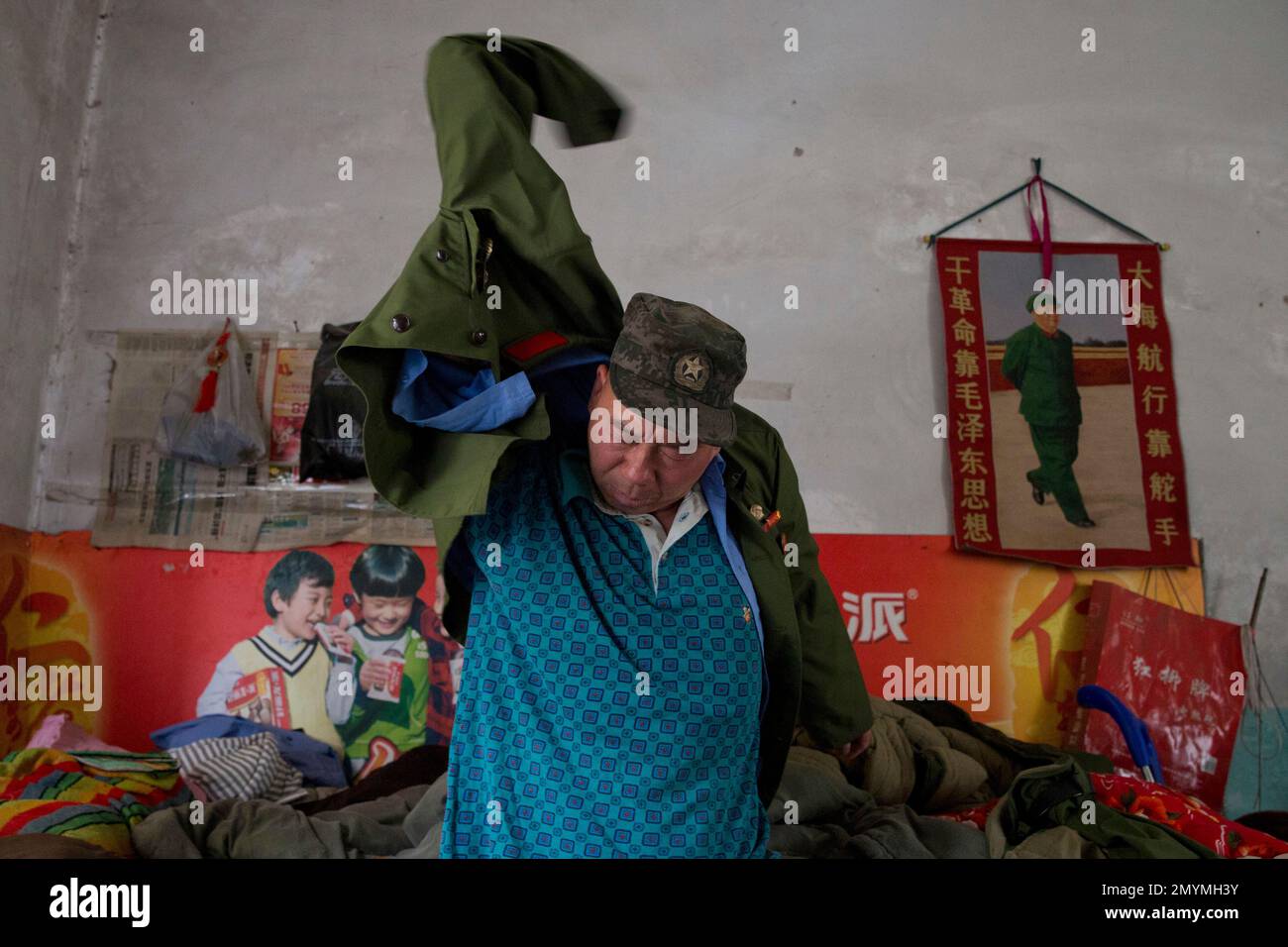 In this May 2, 2016 photo, Zhao Shunli puts on his uniform in his home ...