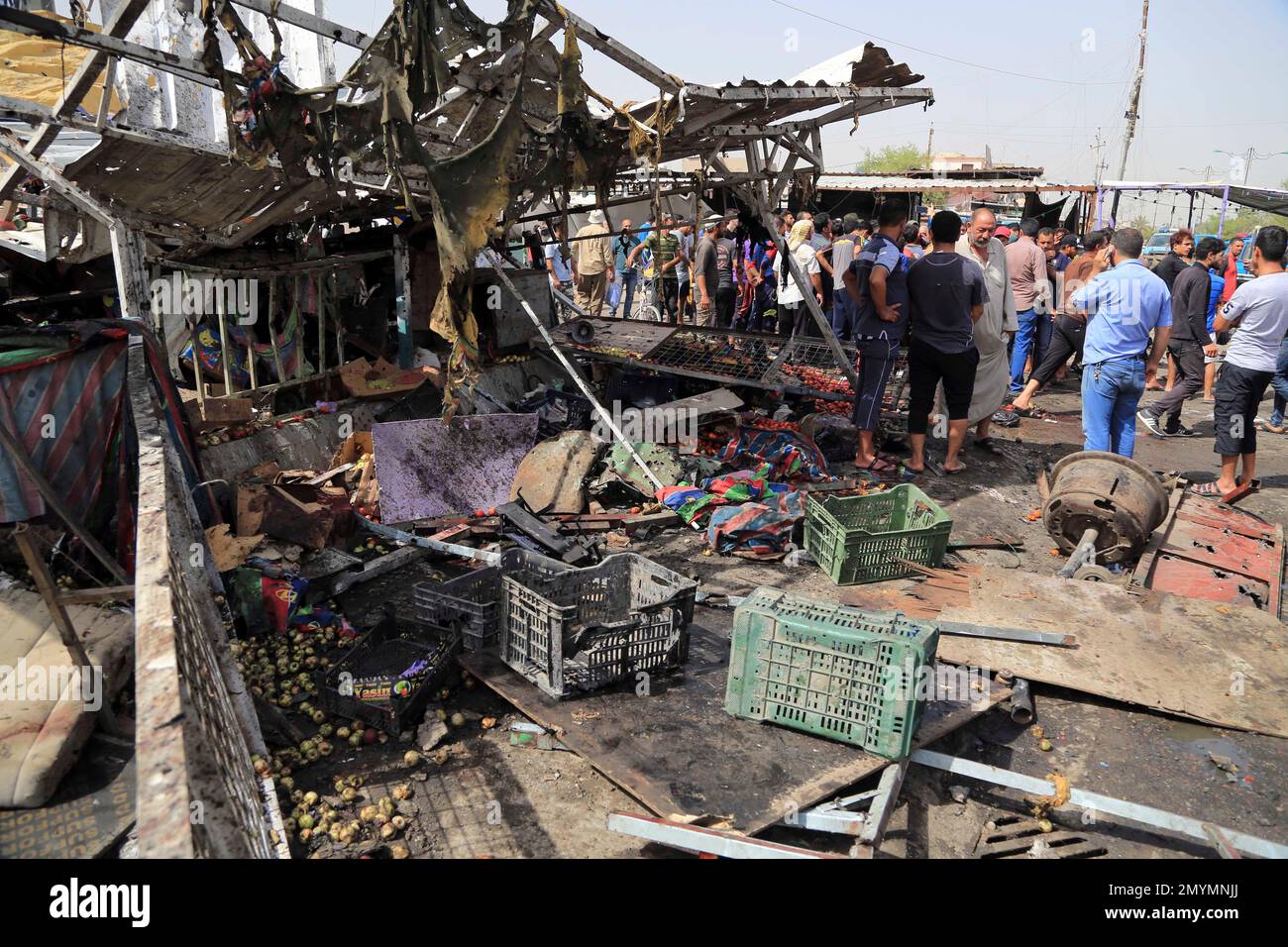Citizens inspect the scene after a suicide car bomb hit a crowded ...