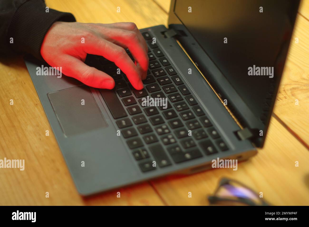 typing on the laptop keyboard on the table with one hand Stock Photo ...