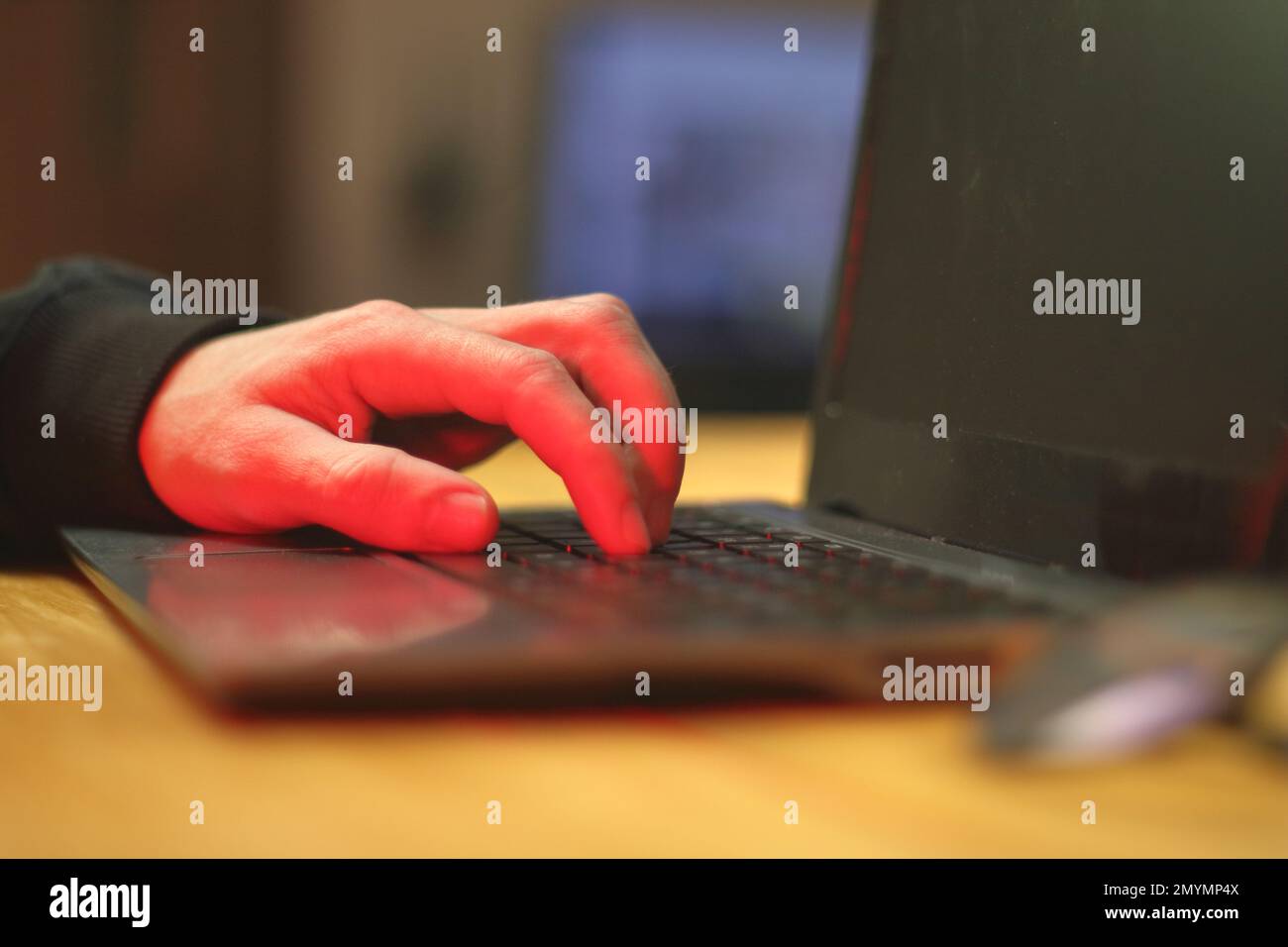 typing on the laptop keyboard on the table with one hand Stock Photo ...