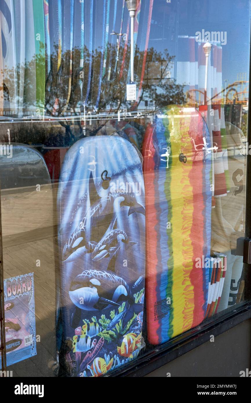 A selection of graphic boogie boards appear behind a reflection in a ...