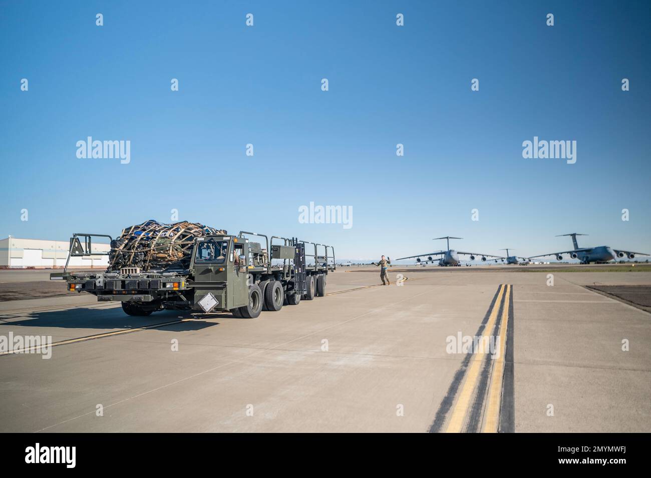 U.S Airmen unload a K-loader and move 2,700 pounds of cargo from a KC ...