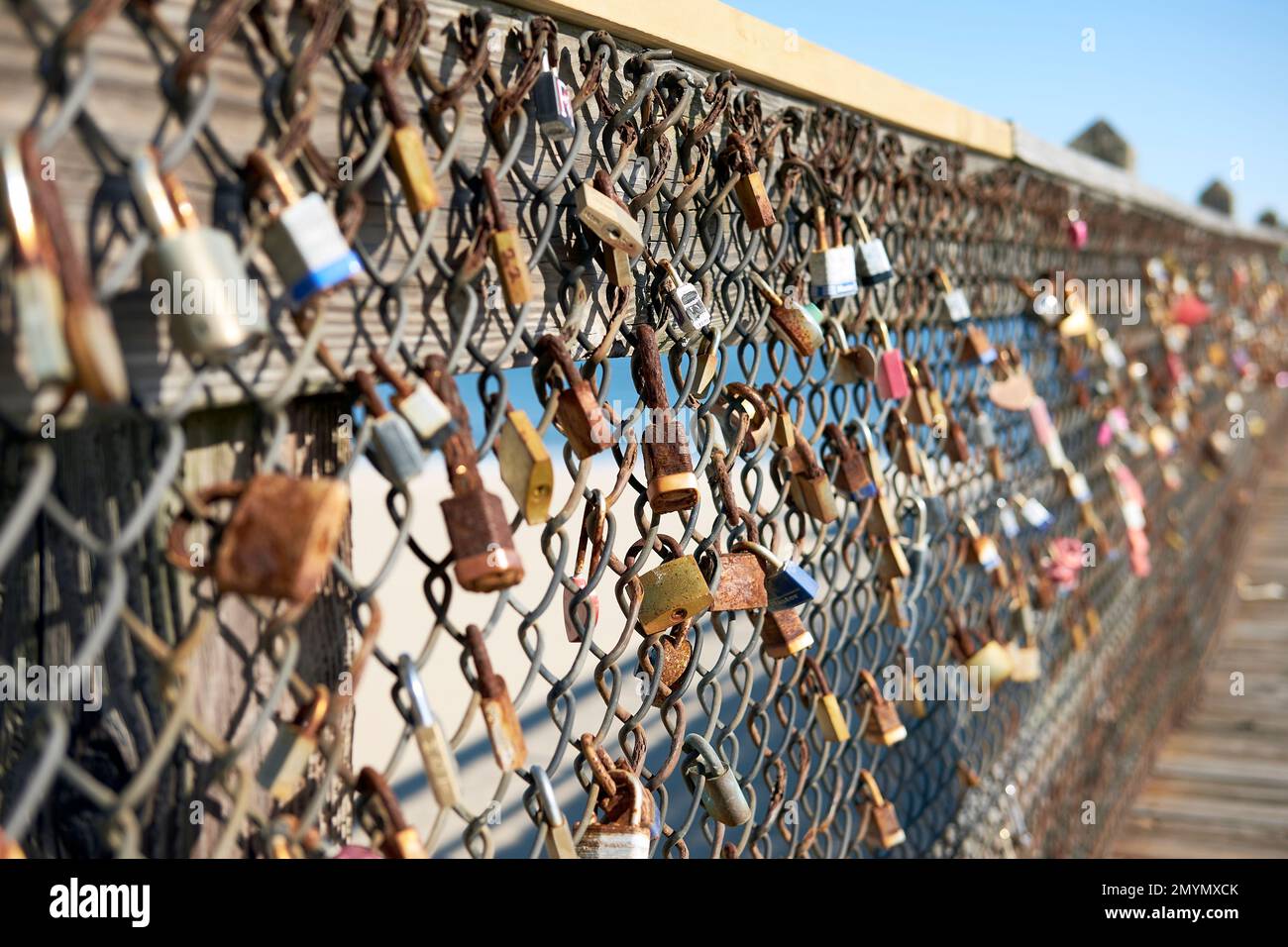 Love lock padlocks hang on a chain link fence Stock Photo - Alamy