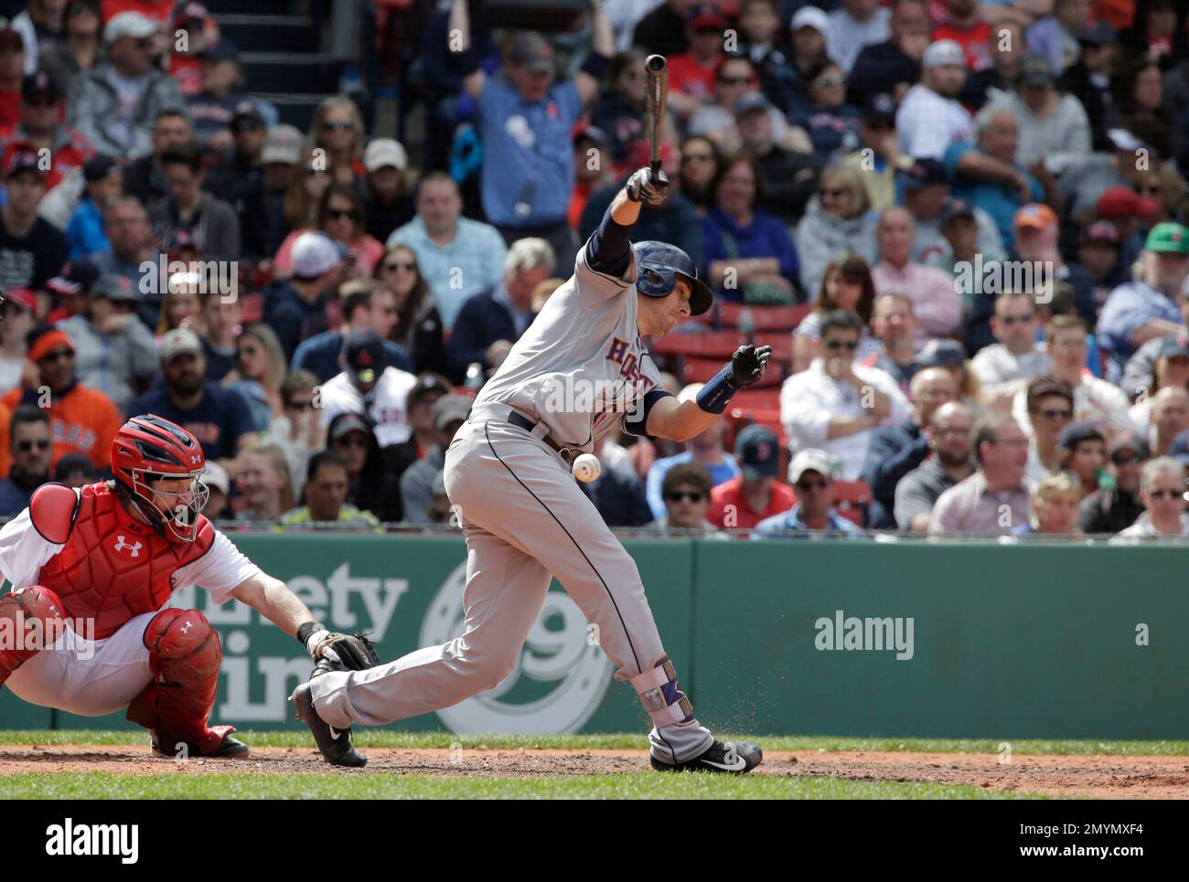 Houston Astros' Jason Castro, right, swings at a pitch as Boston Red ...