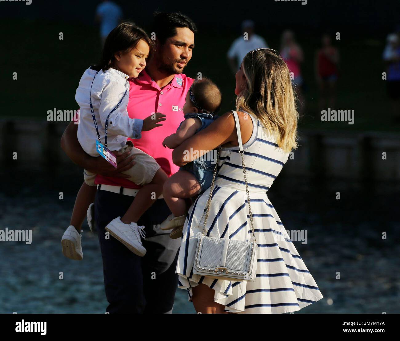 Jason Day of Australia, walks off the 18th green with his family after ...