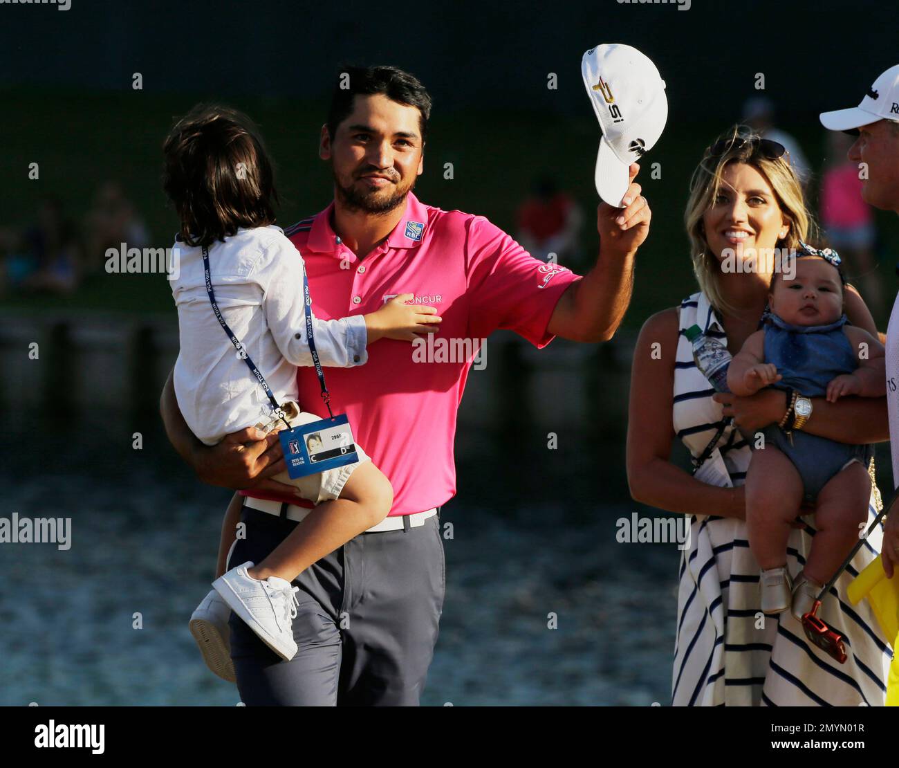 Jason Day of Australia, tips his hat as he walks off the 18th green ...
