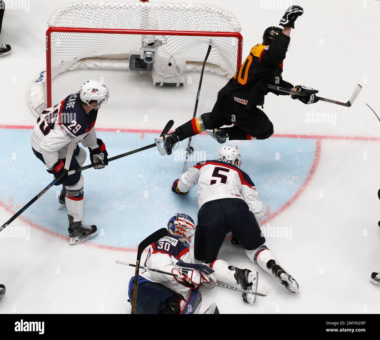 Germany’s Patrick Hager, above, scores a goal to goalkeeper Mike Condon ...