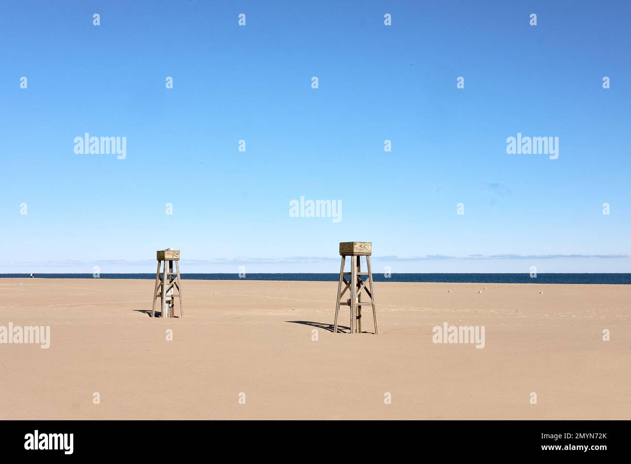 Two wooden structures stand alone on a barren stretch of beach Stock ...