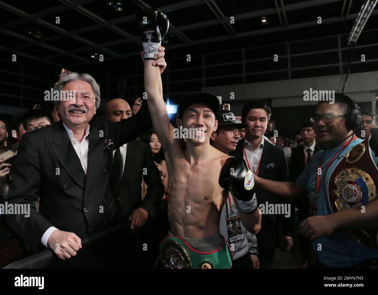 Hong Kong fighter Rex Tso, center, celebrates with Financial Secretary ...