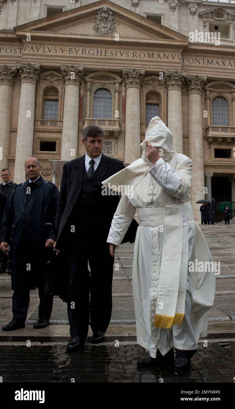 Pope Francis' cape covers his face as its blown by the wind at the end ...