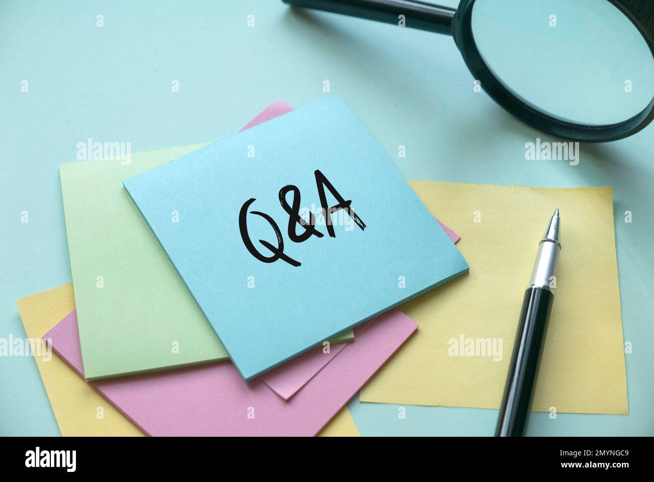 A multi color empty sticky paper note written with Q&A or questions and ...