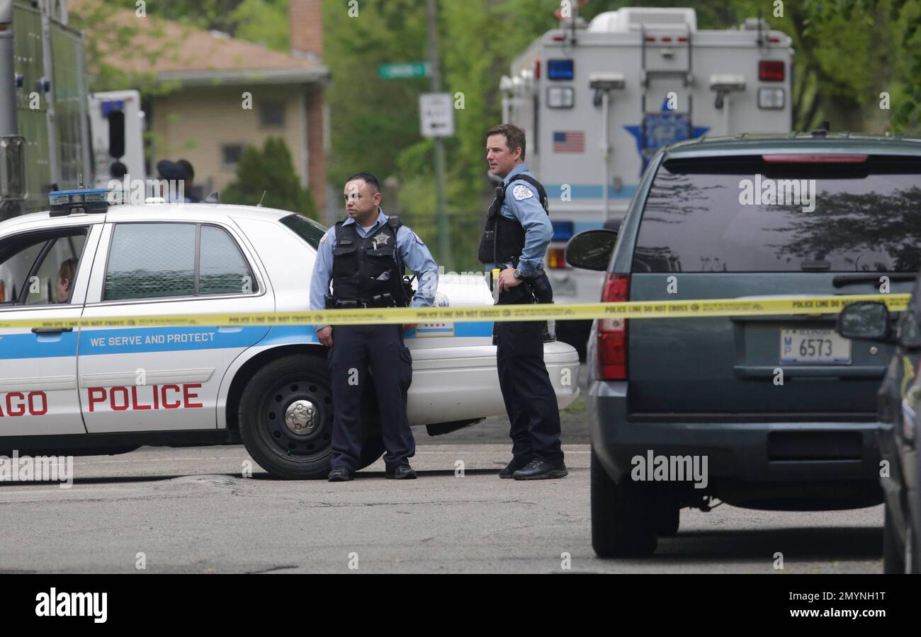 Police cordon off an area where a possible murder suspect has fired ...