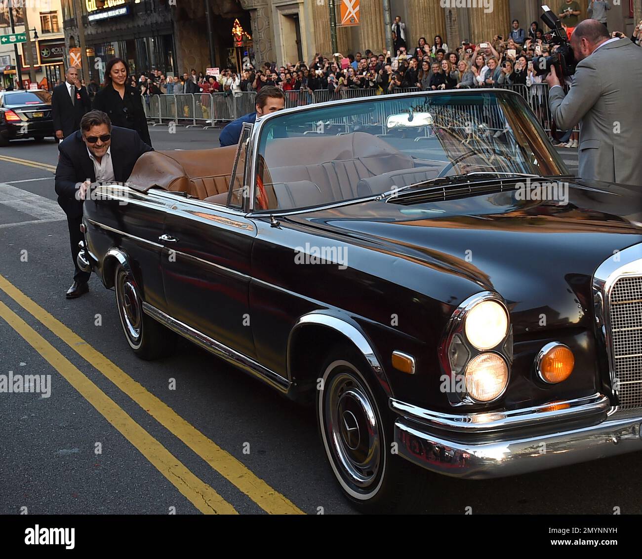 Russell Crowe and Ryan Gosling, attempt to push a car as they arrive at ...