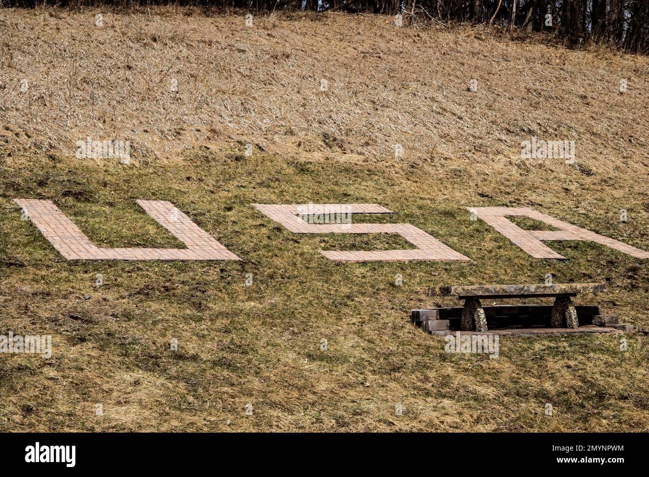 Bench before letters in the grass spelling out USA on a spring day in ...