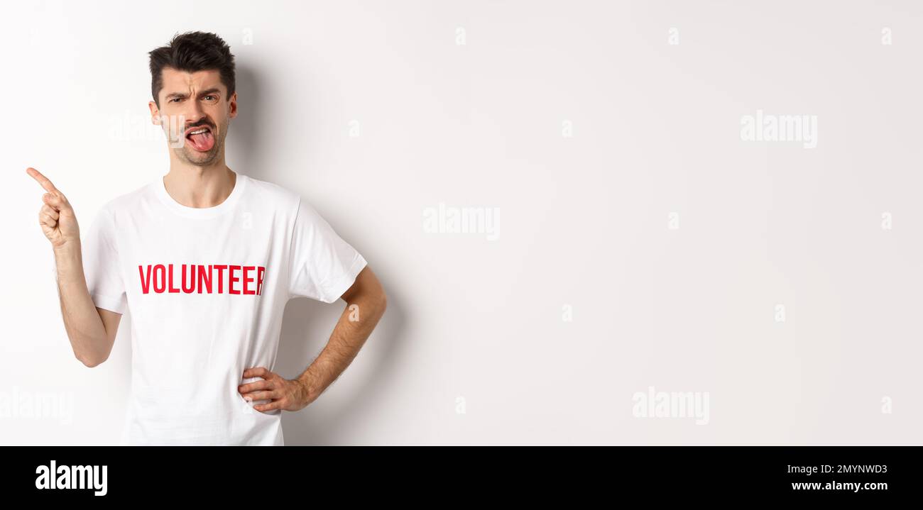 Disappointed volunteer showing bad promo offer, sticking tongue and ...