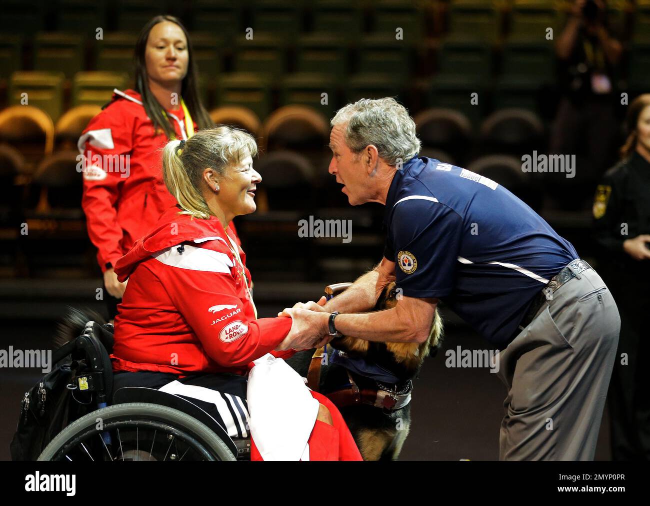 Former President George W. Bush, right, presents a gold medal in women ...