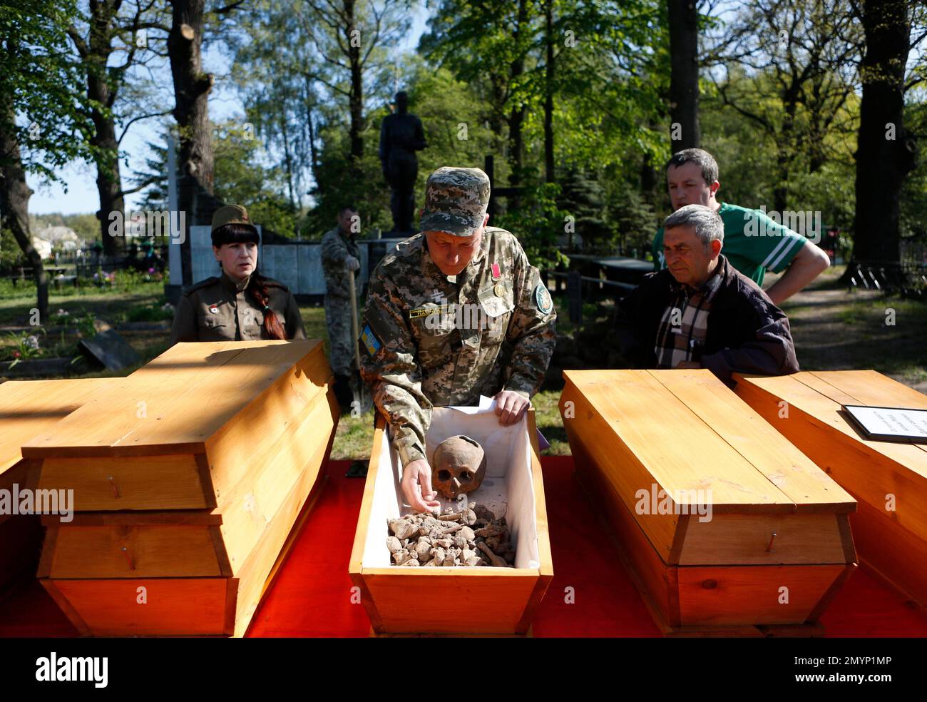 Members of the Ukrainian Fund 'Memory' places the remains of one of the ...