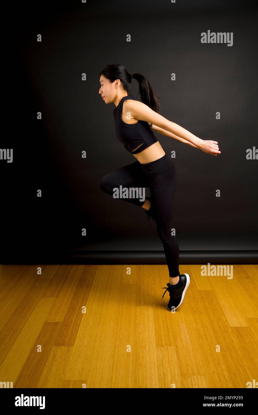 Beautiful Young Asian Woman Lunging / Jumping Forward with Arms Back ...