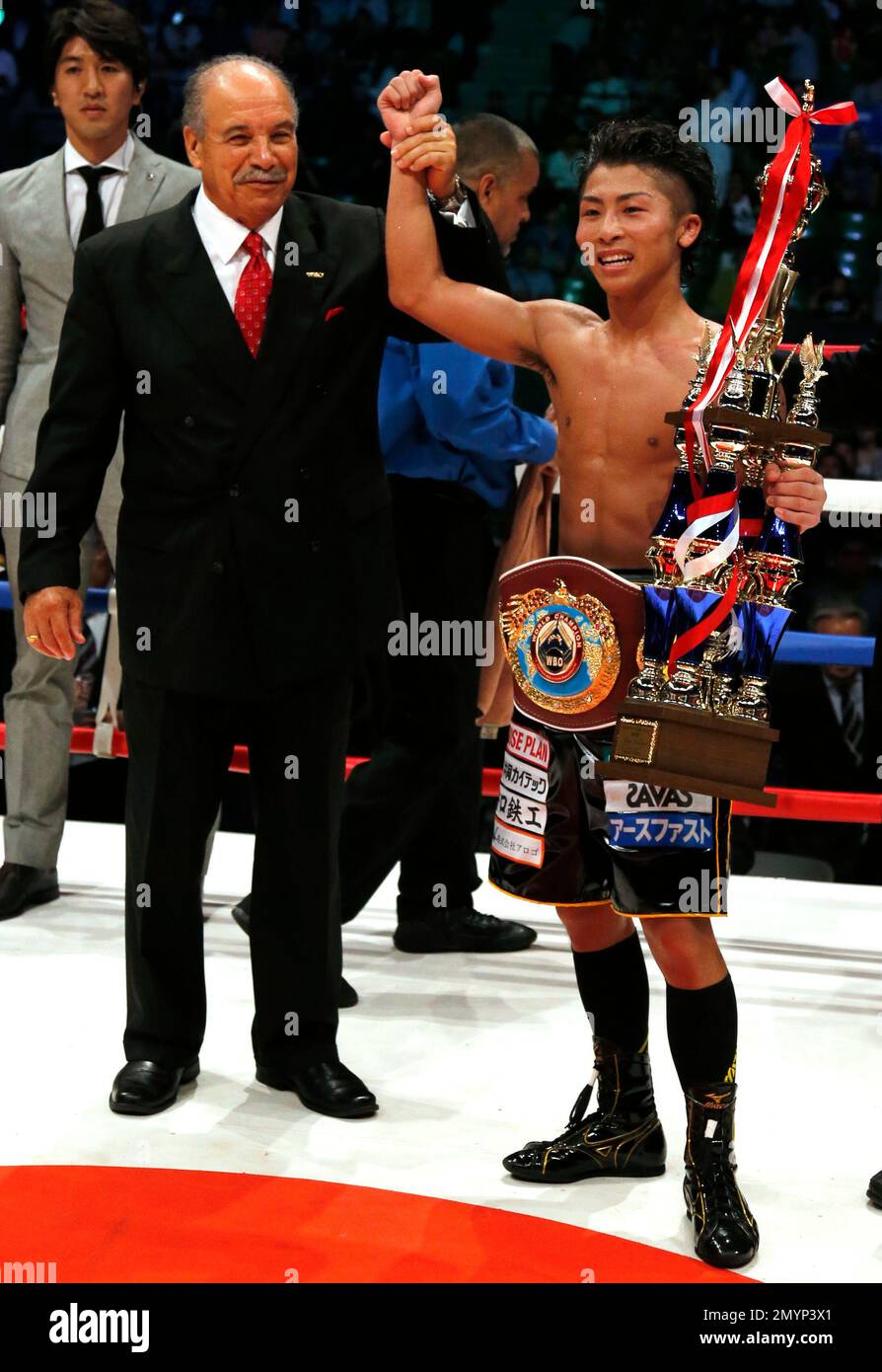 Japanese champion Naoya Inoue holding his trophy is shown to fans after ...