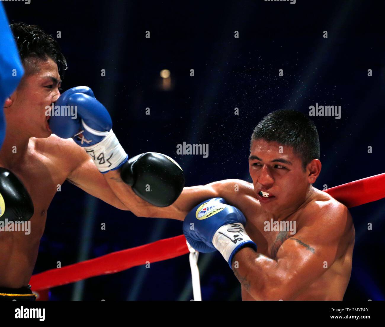 Japanese champion Naoya Inoue, left, receives a punch from Mexican ...