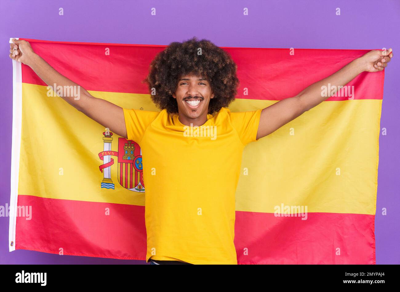 Happy african man raising a spanish flag Stock Photo - Alamy